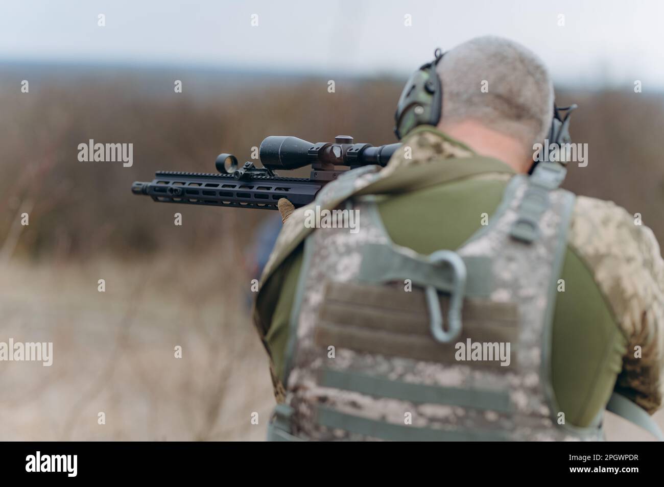 A military soldier of the army is firing a machine gun. Shooting and ...