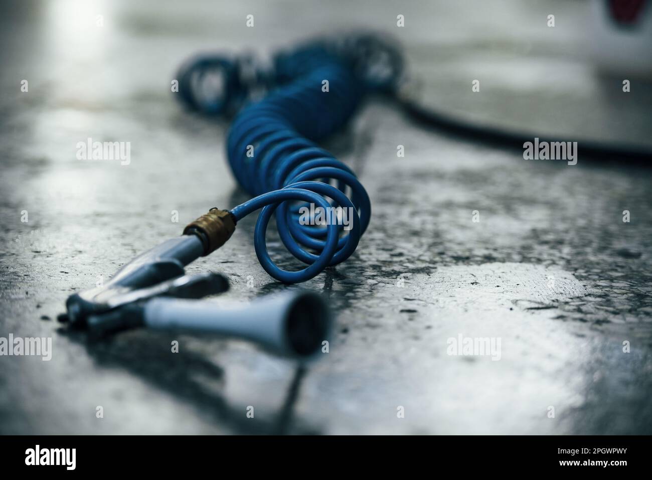 Close up view of blue car wash instrument that lying down on the ground ...