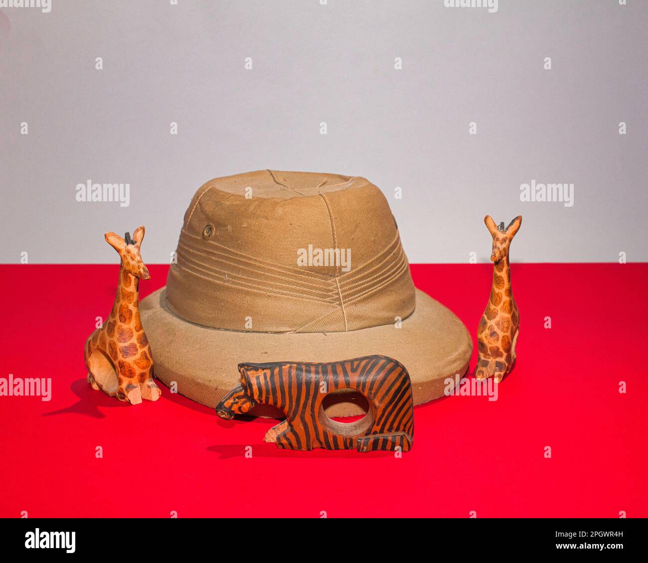 Colonial helmet, with puppets of African craftsmanship Stock Photo - Alamy