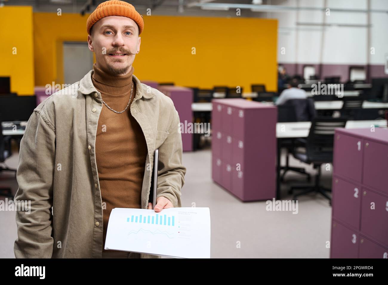 Corporate worker with business documentation standing in open-place ...