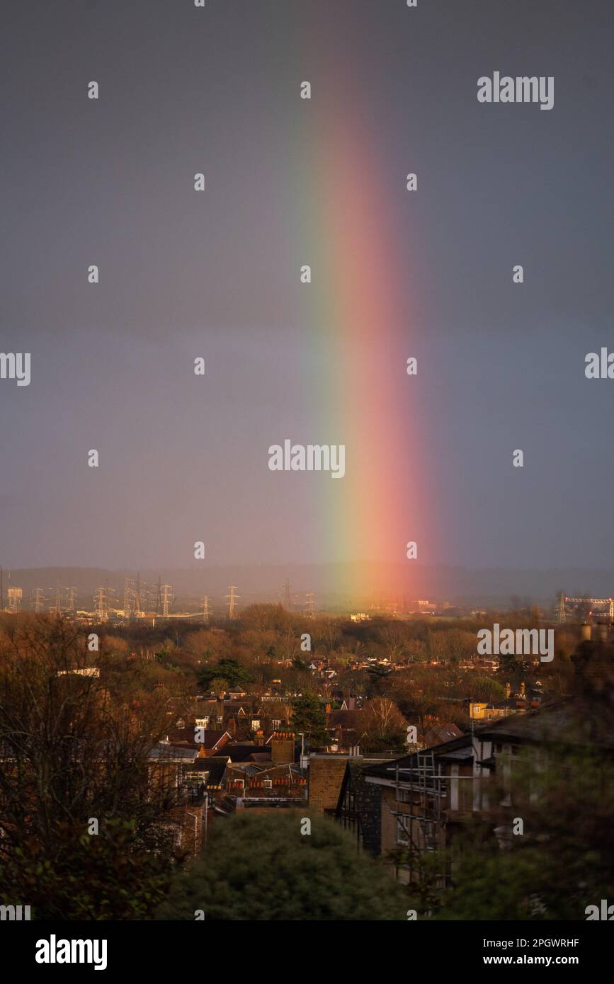 London UK 24 March. 2023. The end of colourful rainbow appears over ...