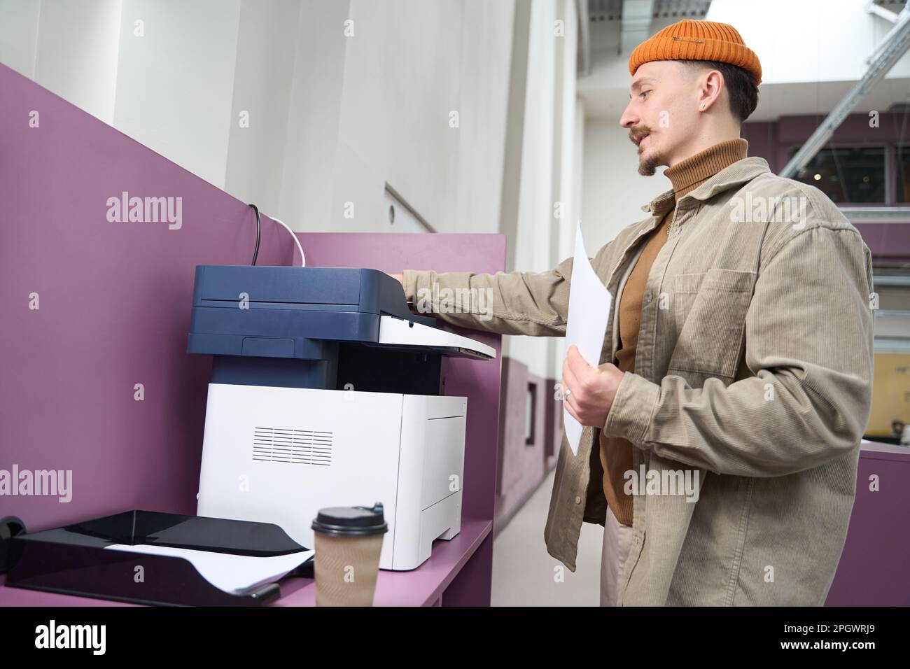 Focused company employee making photocopies on copier Stock Photo - Alamy