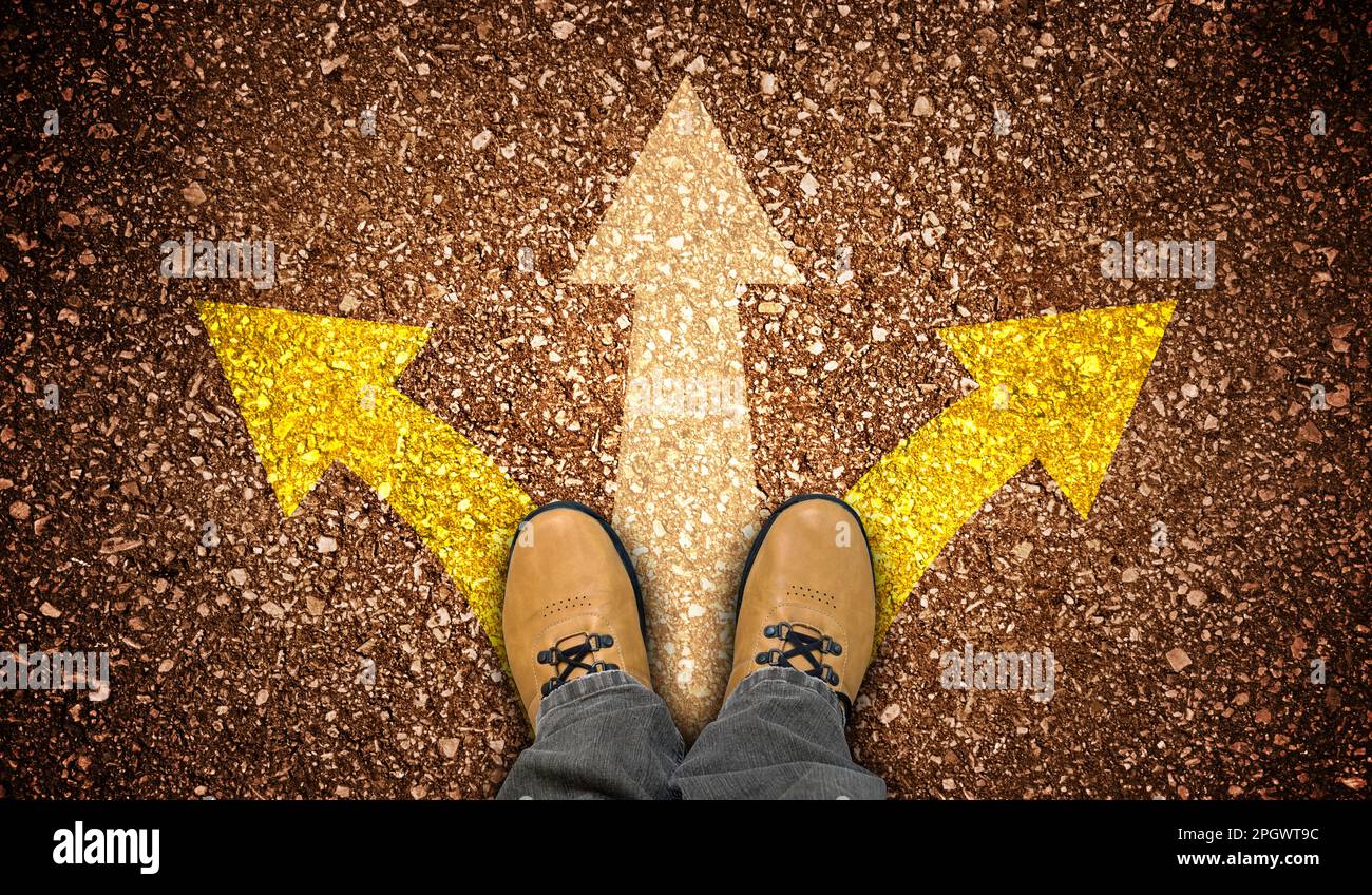 Yellow leather shoes and three colorful chalky arrows on ground ...