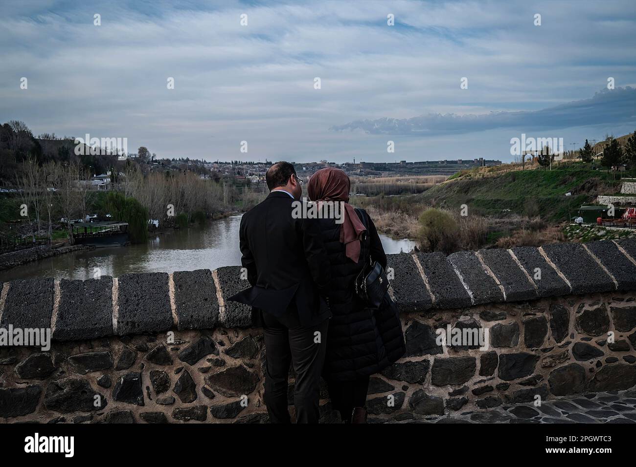A couple was seen looking over the Tigris River over a bridge. The ...