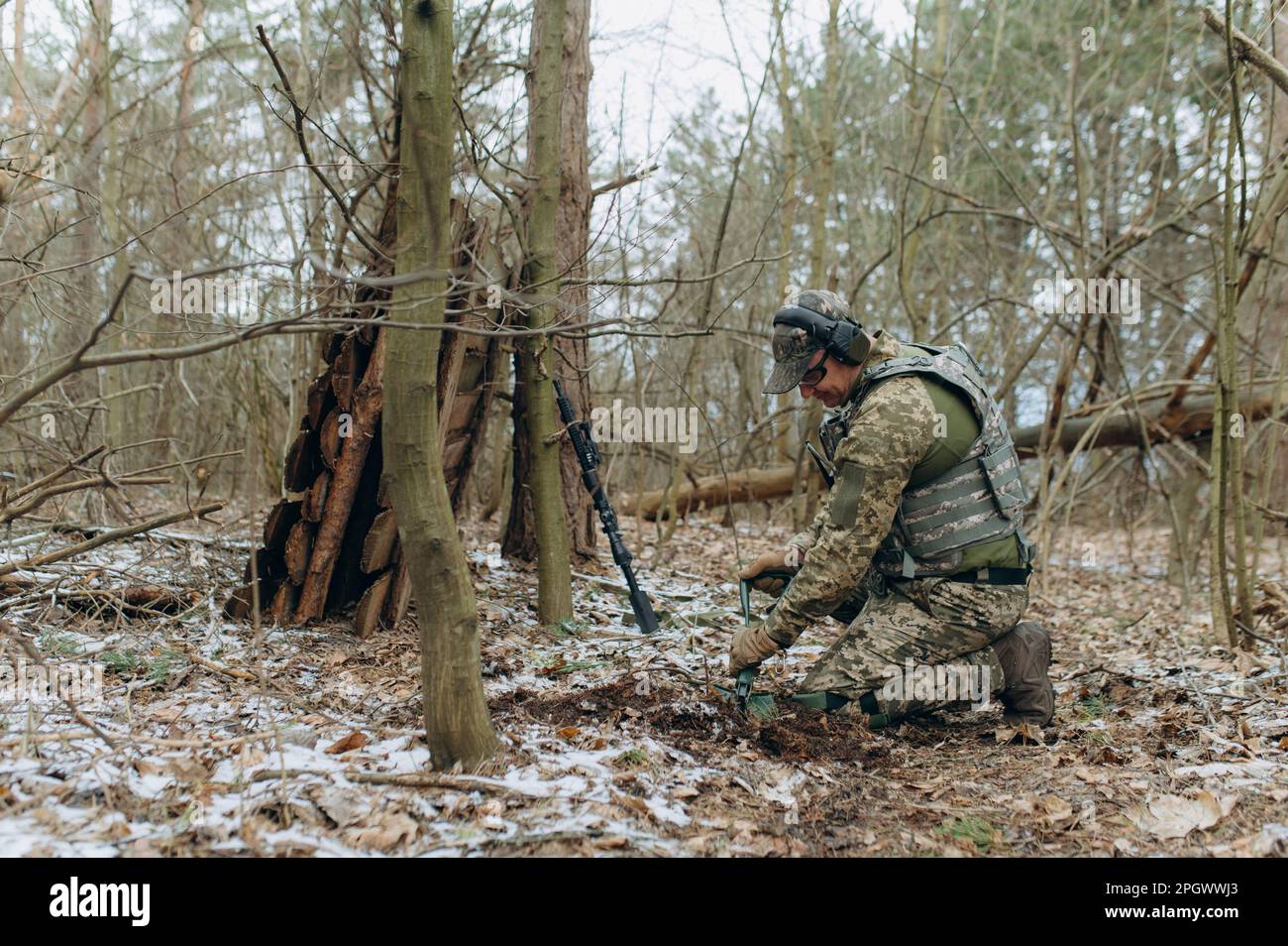 a soldier with a shovel in his hand digs the ground Stock Photo - Alamy
