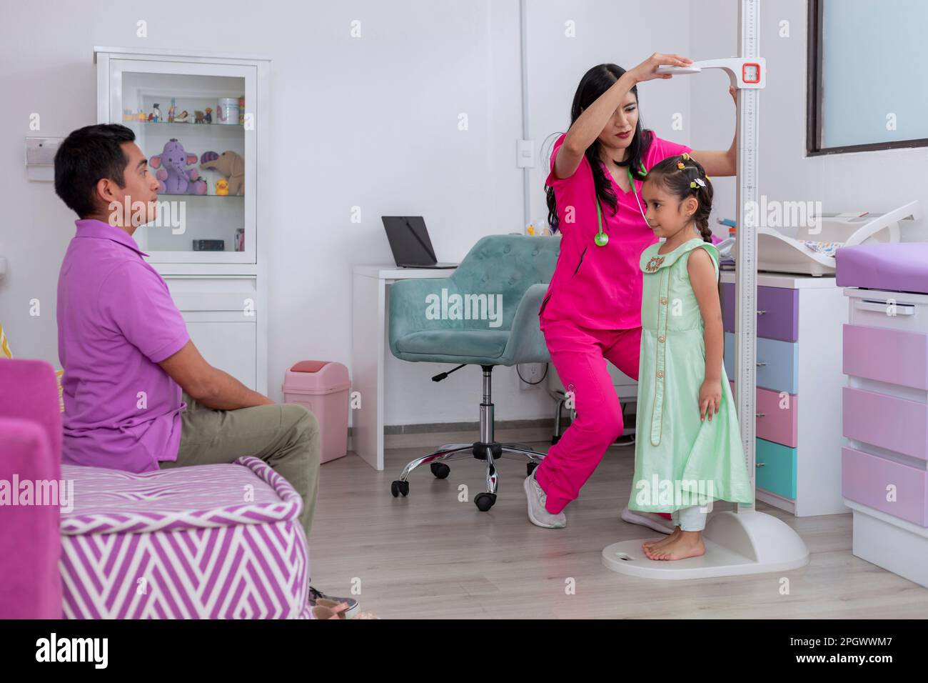 Dad with his daughter in the pediatrician doctor's office, while they ...