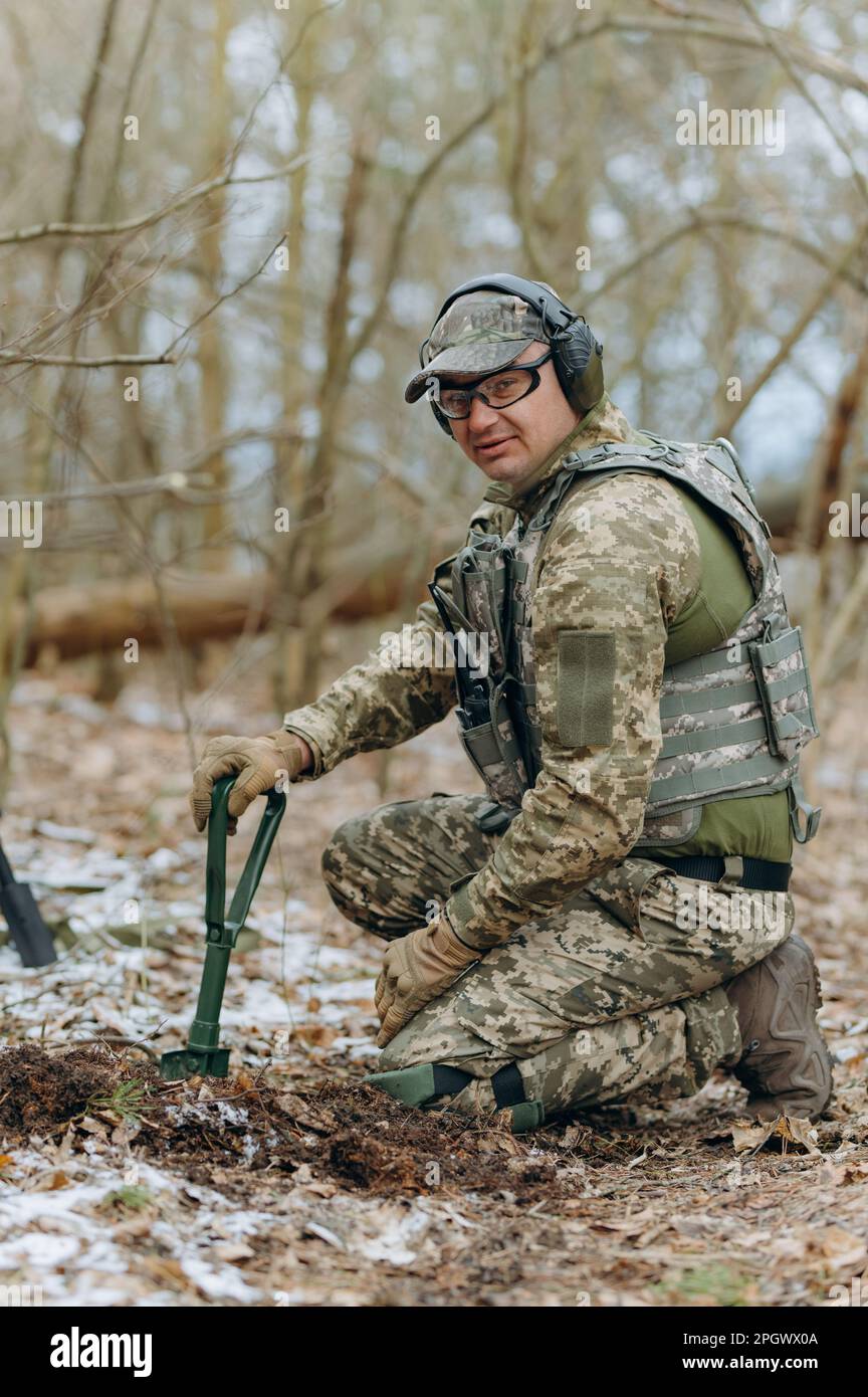Preparation for the attack. Digging a trench Stock Photo - Alamy