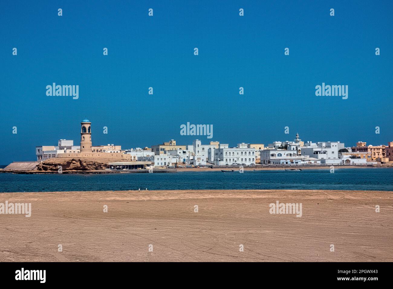 The Al Ayjah lighthouse and whitewashed village in Sur, Ash Sharqiyah ...