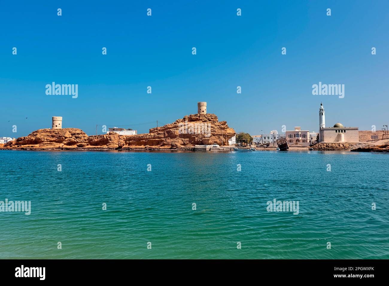 View of fort and castle ruins and the whitewashed coastal town of Al ...