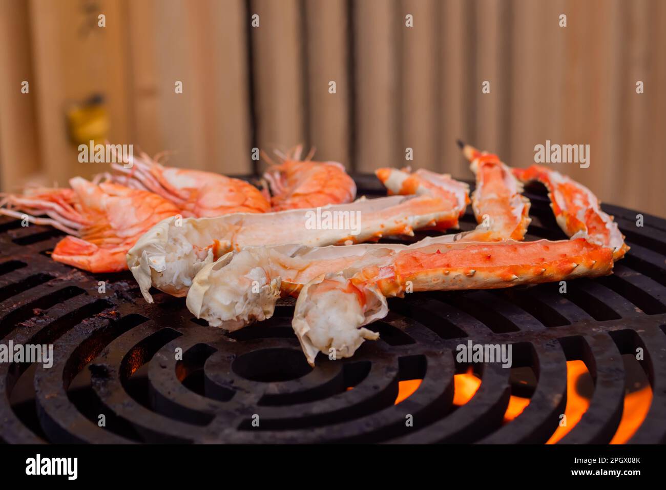Process of cooking fresh red crab legs and prawns on grill Stock Photo ...