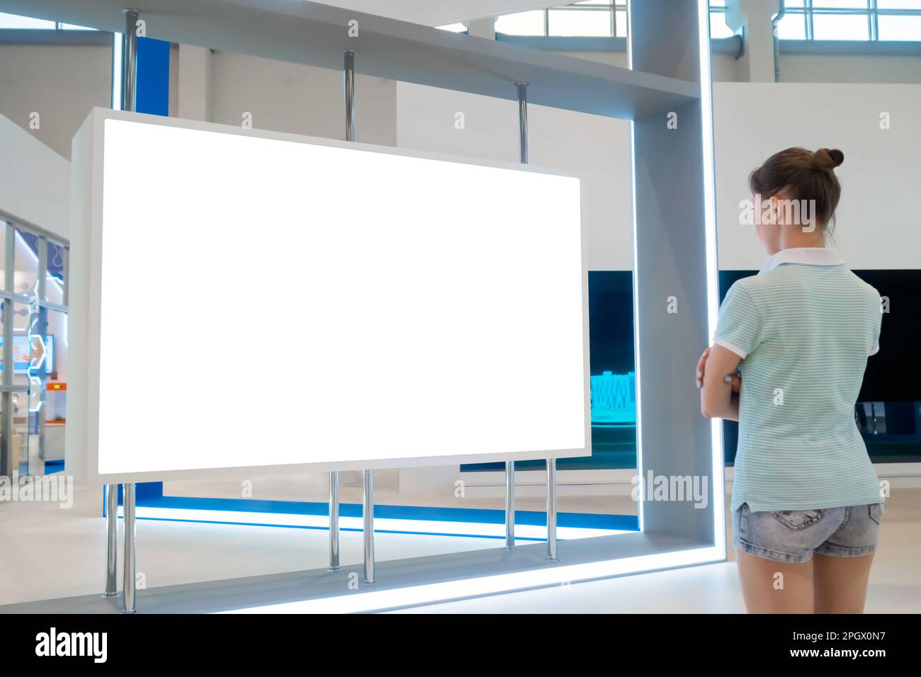 Woman looking at blank white display wall at exhibition - white screen ...