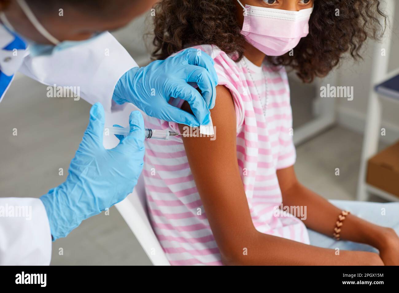 Doctor holds syringe and disinfects place on child's hand before ...