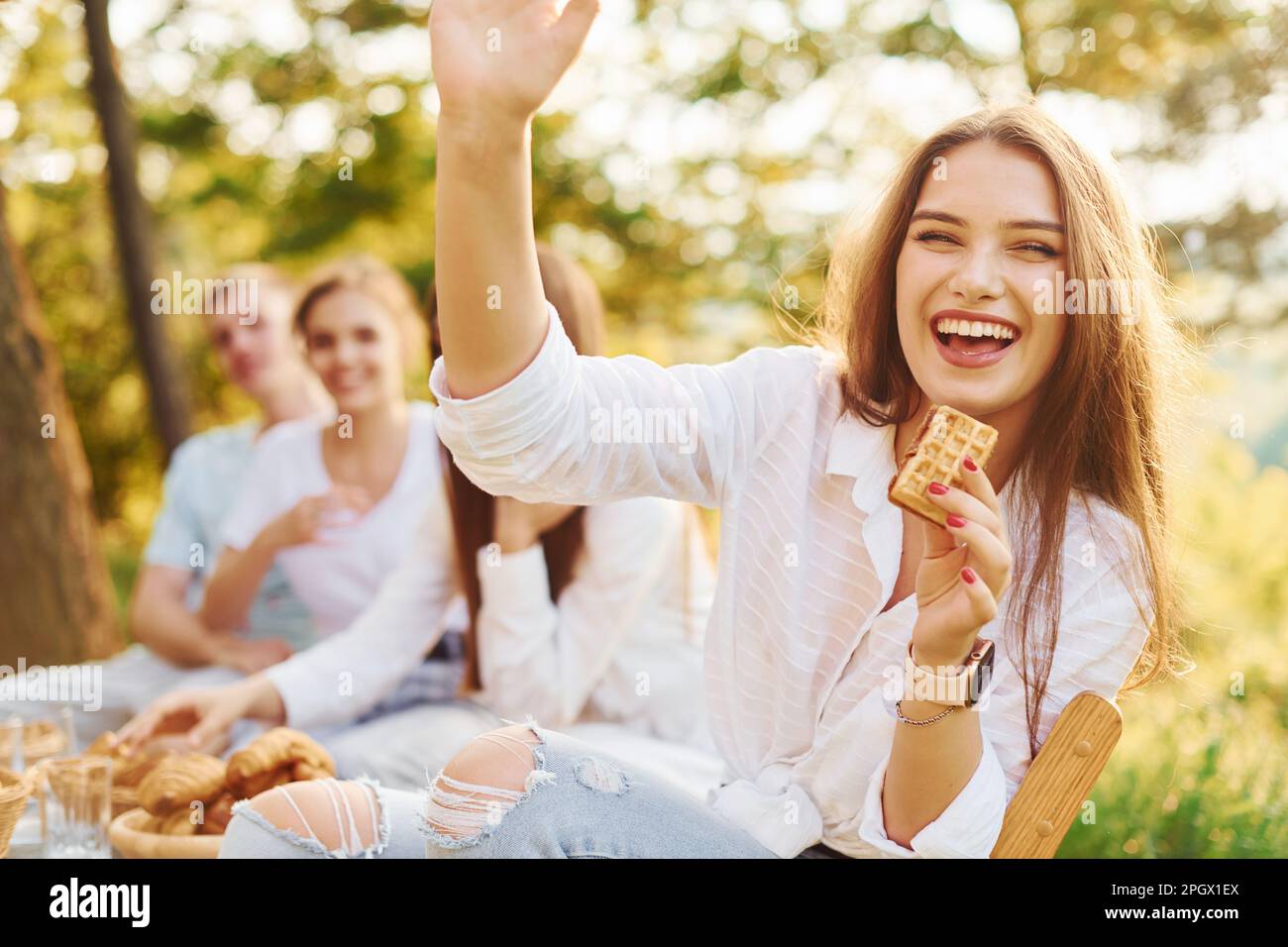 Woman giving high five to photographer. Group of young people have ...