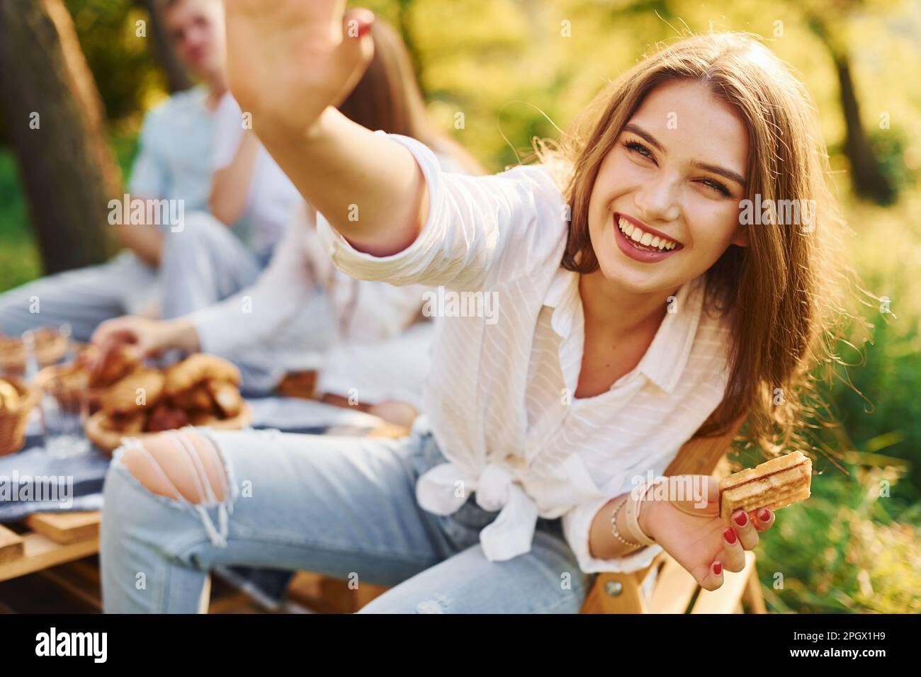 Woman giving high five to photographer. Group of young people have ...