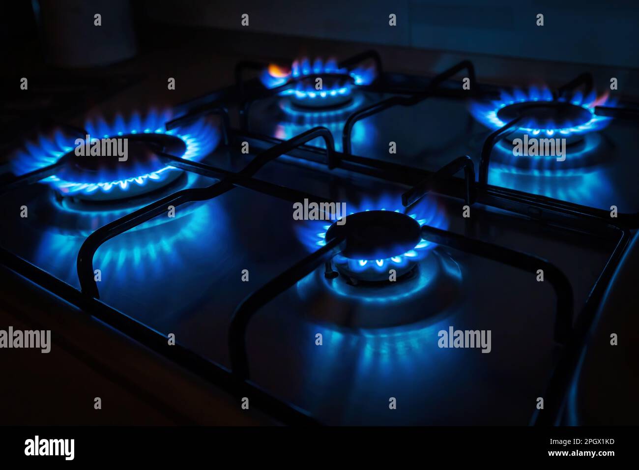 Domestic gas cooker with burners lit Stock Photo - Alamy