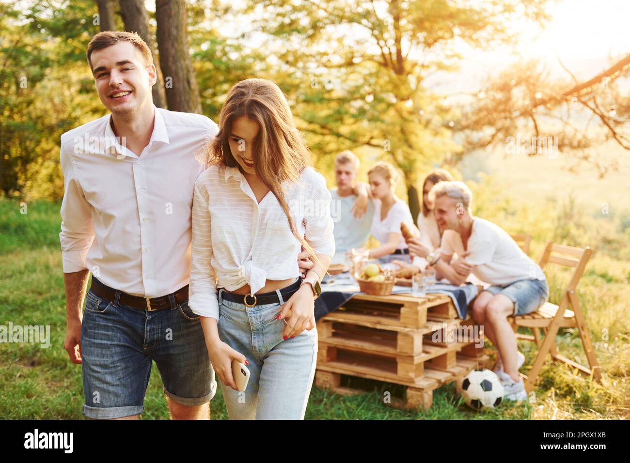 Happy couple. Group of young people have vacation outdoors in the ...