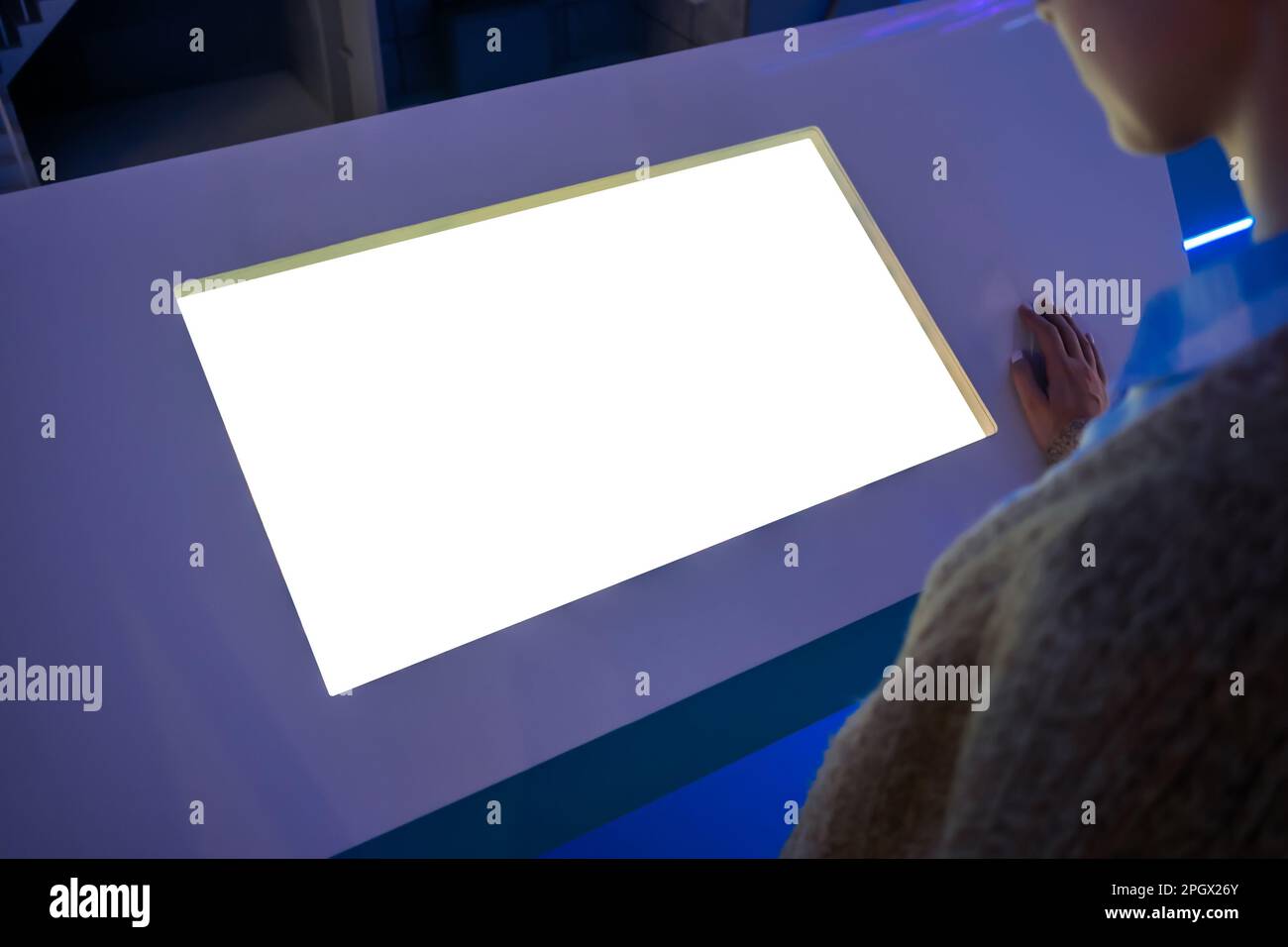 White screen concept - woman looking at blank white display kiosk at ...