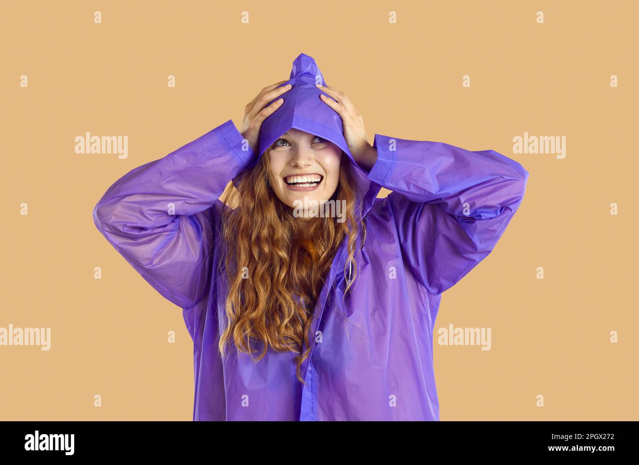 Cheerful happy smiling beautiful young woman hiding from rain under ...