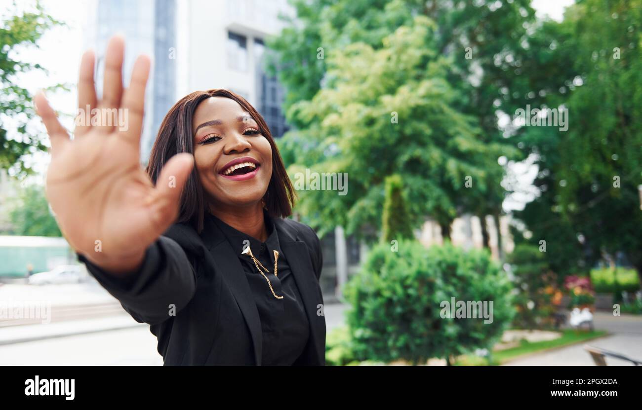 High five gesture. Young afro american woman in fashionable clothes ...