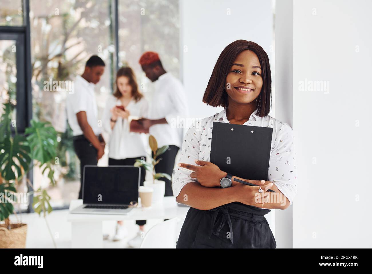 Woman holding notepad. Group of african american business people ...