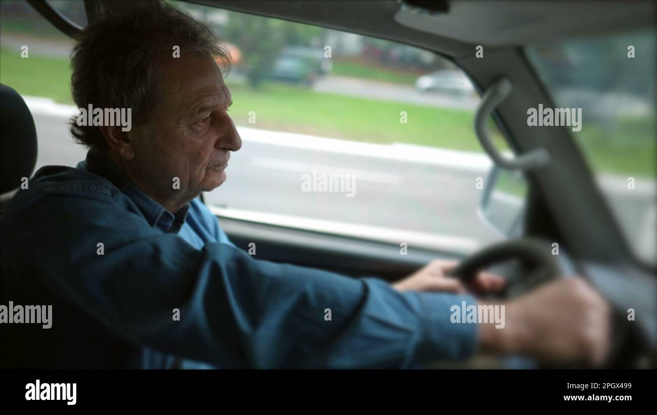 Senior driving inside moving vehicle. Older person holding car steering ...