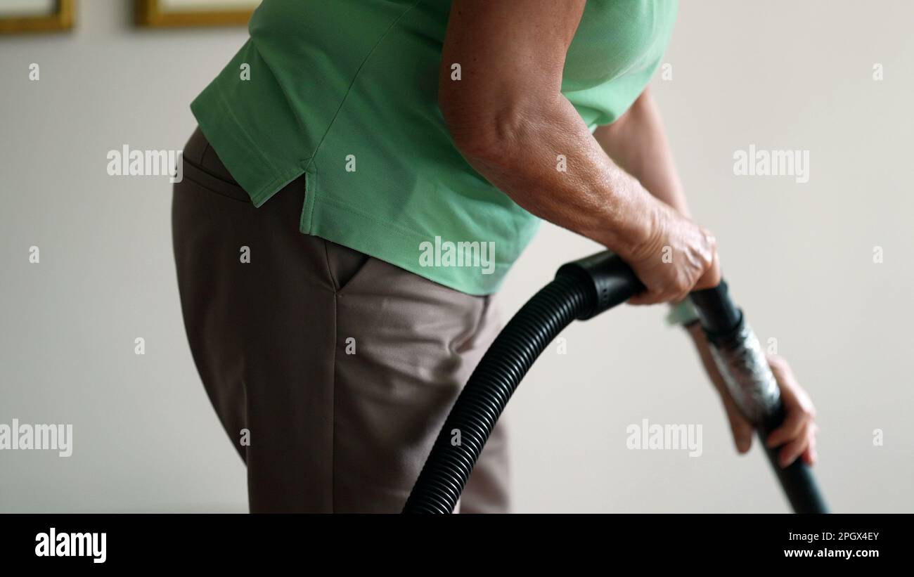Senior woman doing vacuum cleaning hi-res stock photography and images ...