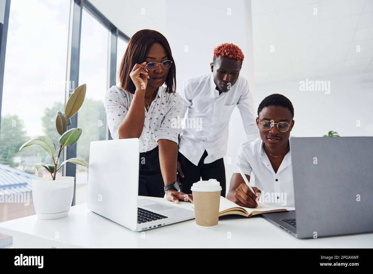 Using same laptop for the project. Group of african american business ...