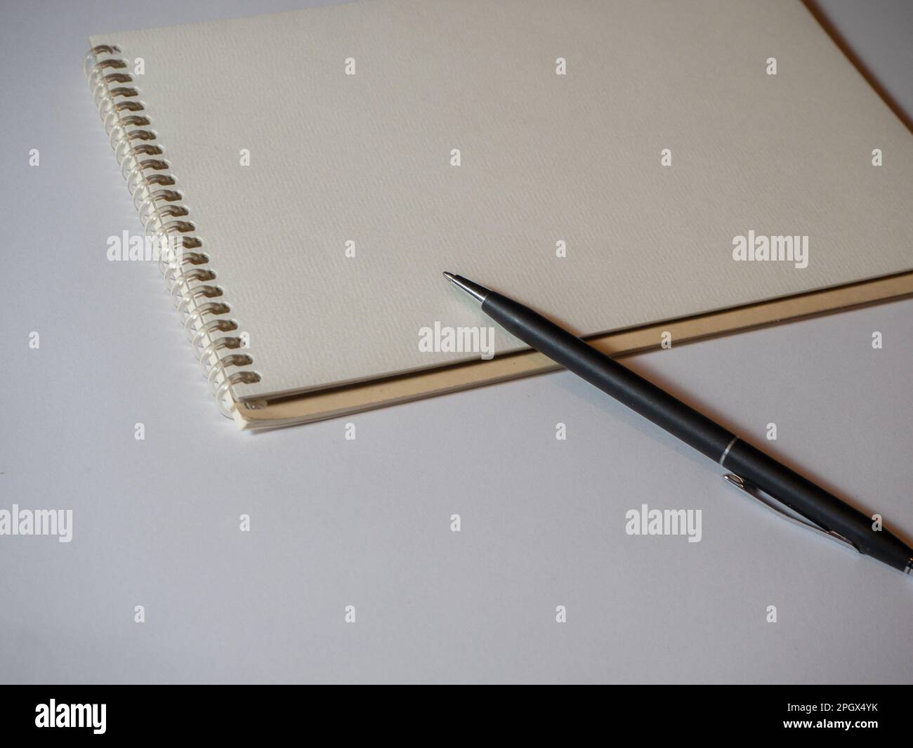 Notepad with pen on white background Stock Photo - Alamy