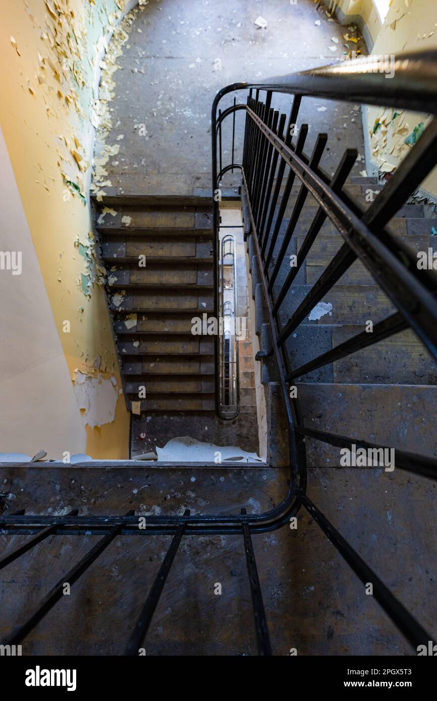 Top view of an old rectangular spiral staircase in an old abandoned ...