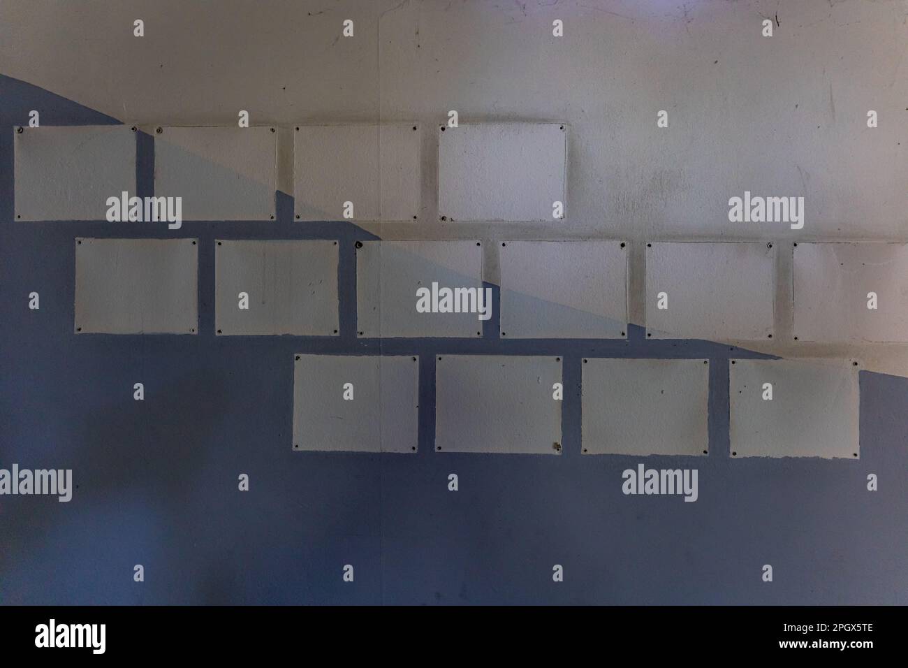 The wall of the old hospital full of traces of old information boards ...