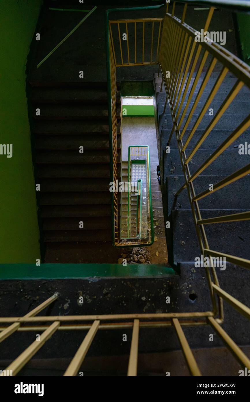 Top view of an old rectangular spiral staircase in an old abandoned ...
