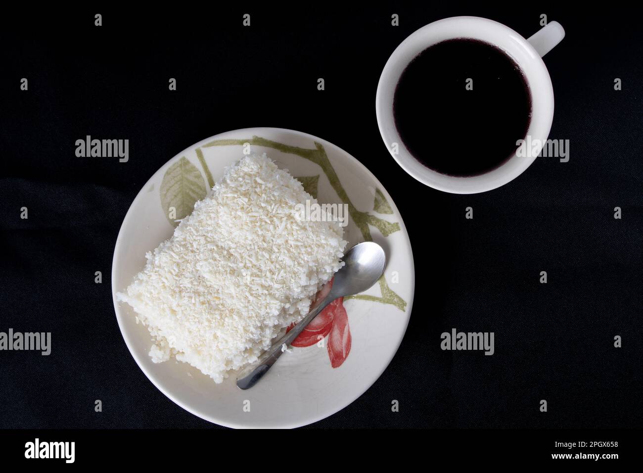 Piece of couscous in porcelain saucer on black background, typical ...