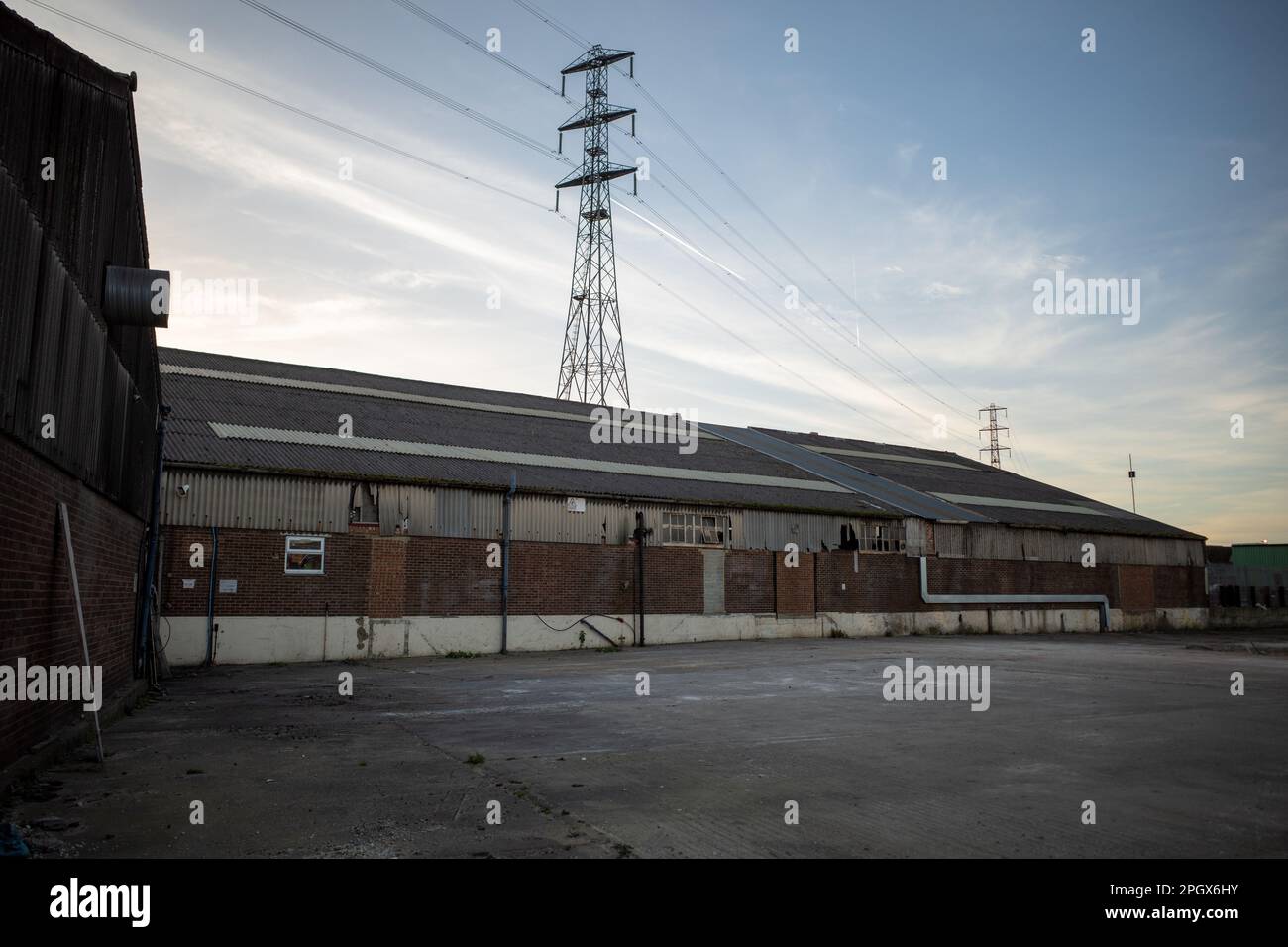 Old run down warehouse with Pylon in the background, in Barking, East ...