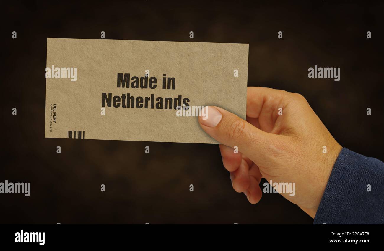 Made in Netherlands box in hand. Manufacturing and delivery. Product ...