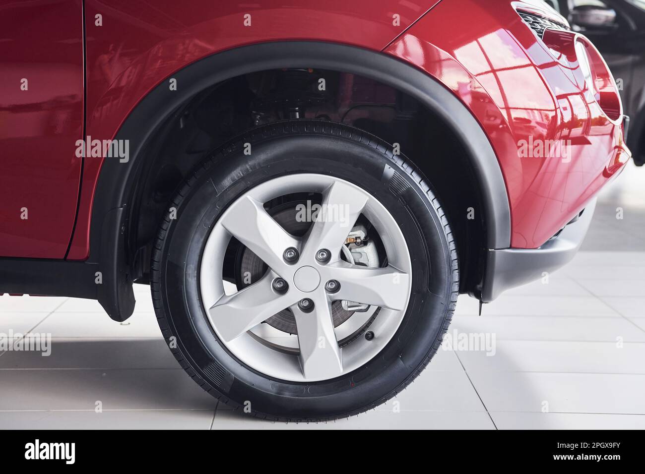 Close up view of automobile's wheel. Brand new car parked indoors Stock ...