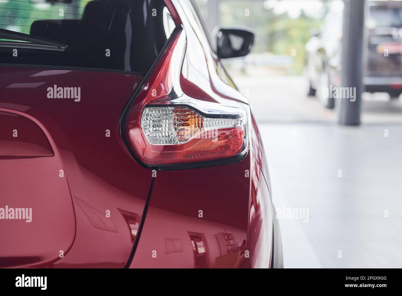Rear particle view of brand new red car that parked indoors Stock Photo ...