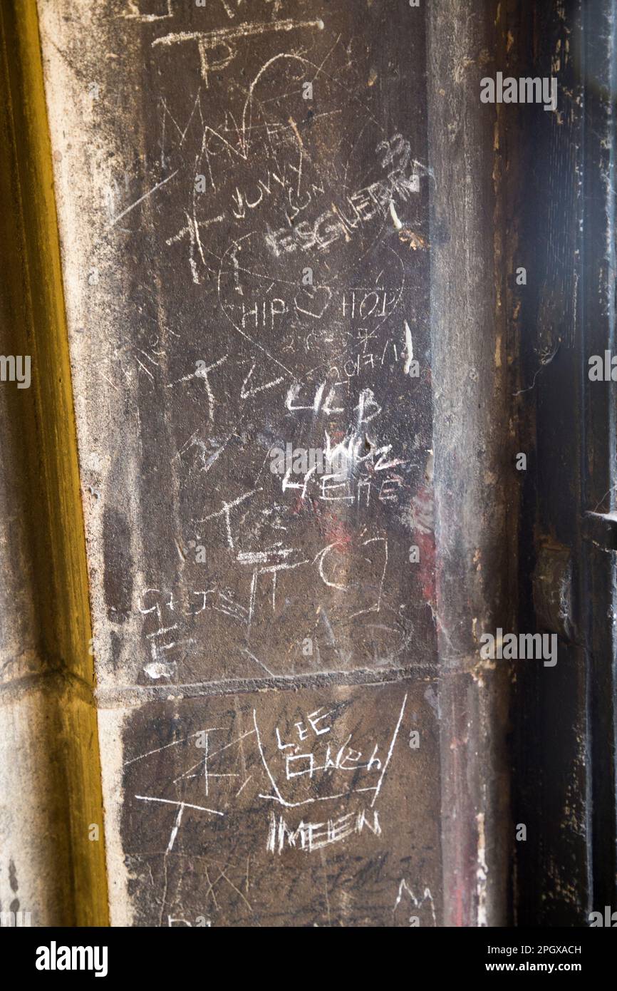 Graffiti petty vandalism scratched into stonework of window on ...