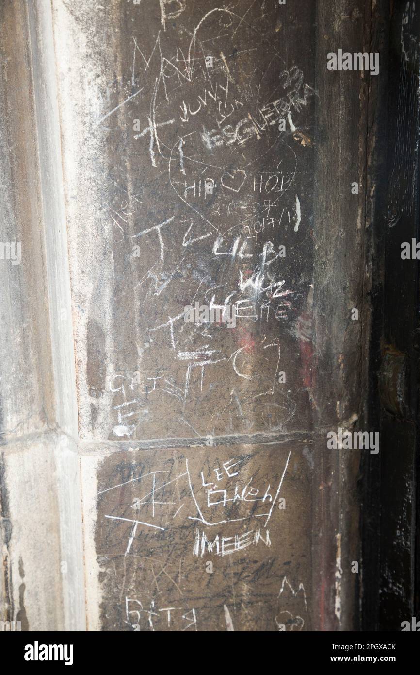 Graffiti petty vandalism scratched into stonework of window on ...