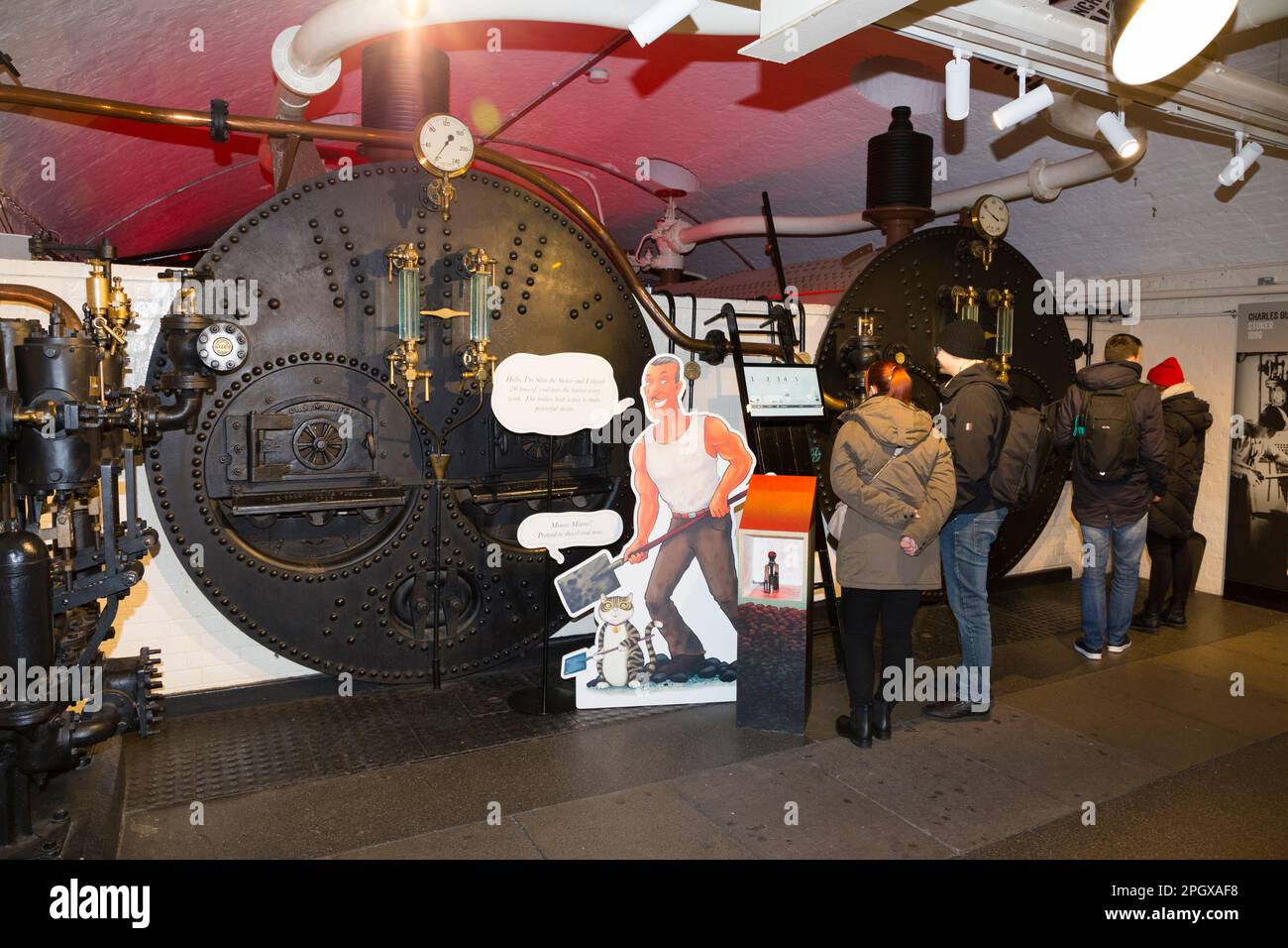 Tourists view the Victorian coal powered boilers in the Engine Rooms of ...