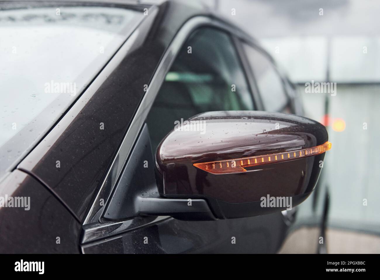 Front particle view of black modern automobile. Side mirror Stock Photo ...