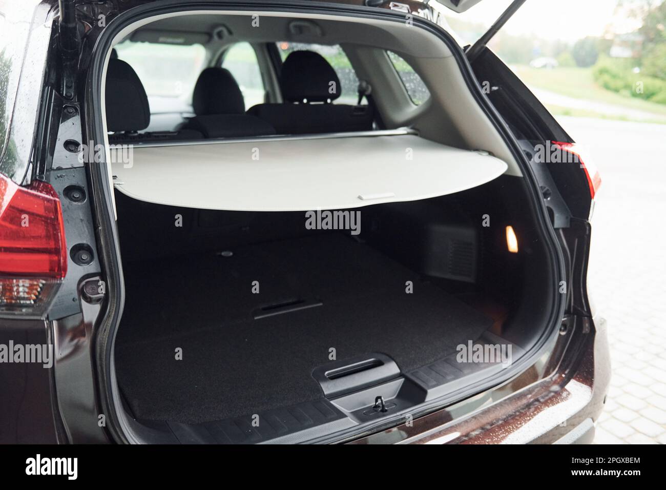 Rear particle view of modern black automobile with car trunk open Stock ...
