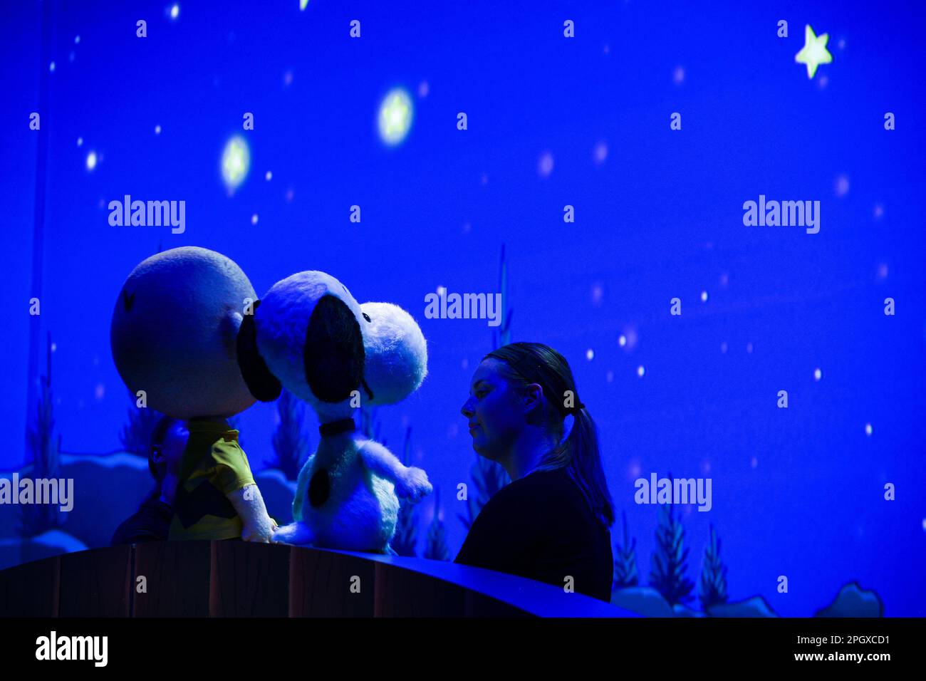 Peanuts characters Charlie Brown and Snoopy and their puppeteers gaze ...