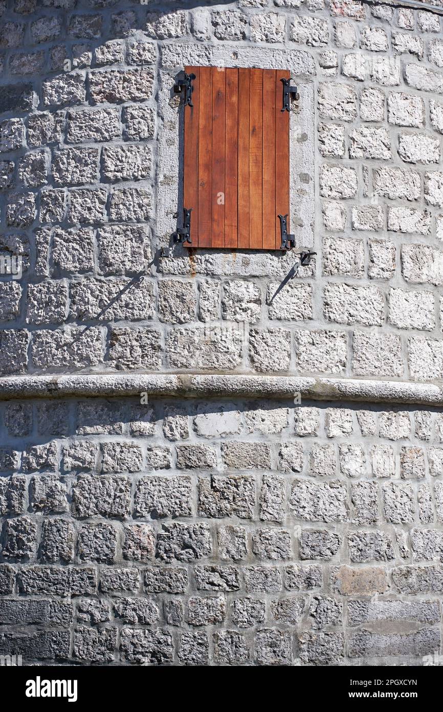 Castle round tower of bricks with lonely window and wooden shutter ...