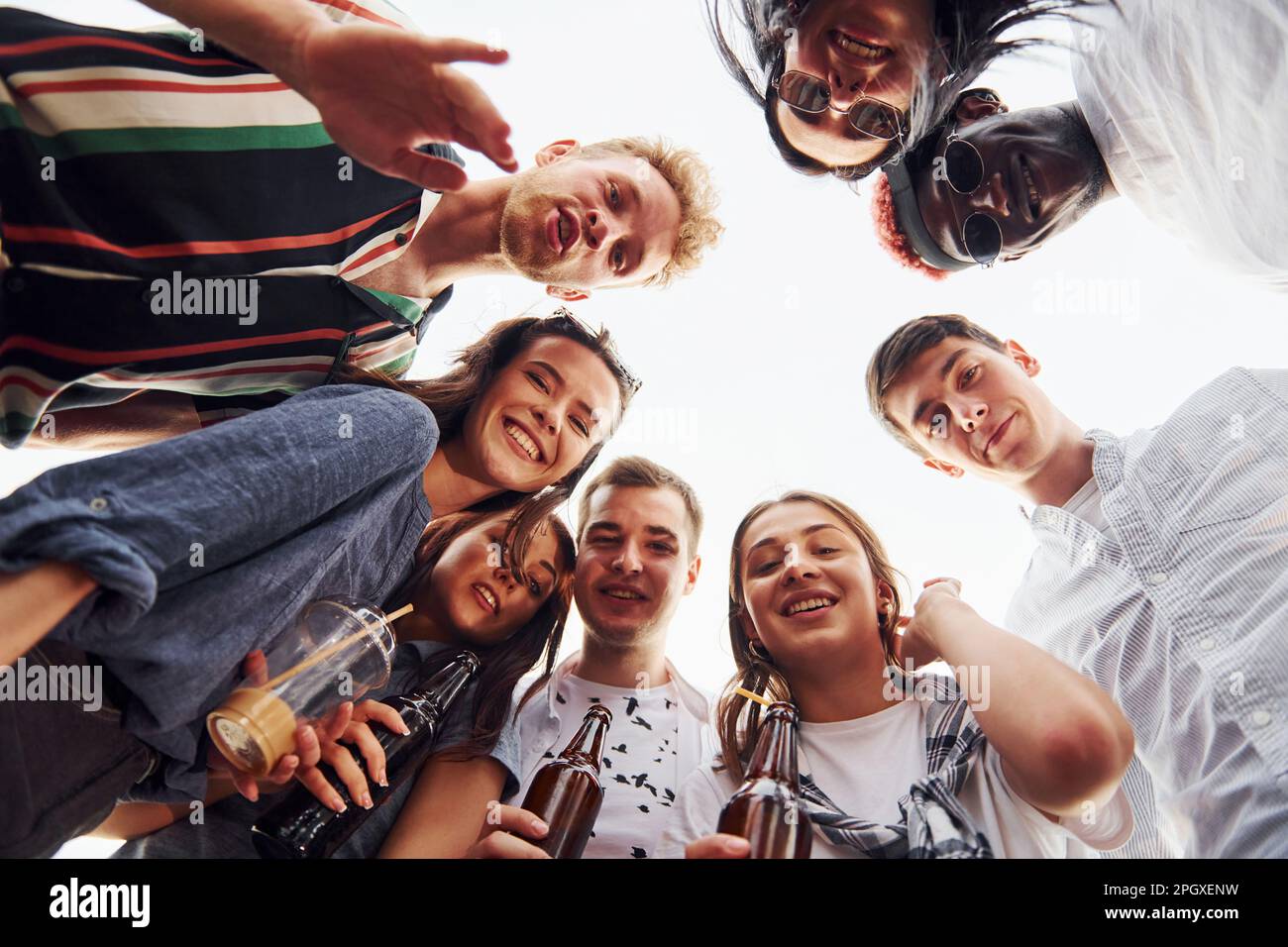 Looking down. View from below. Group of young people in casual clothes ...
