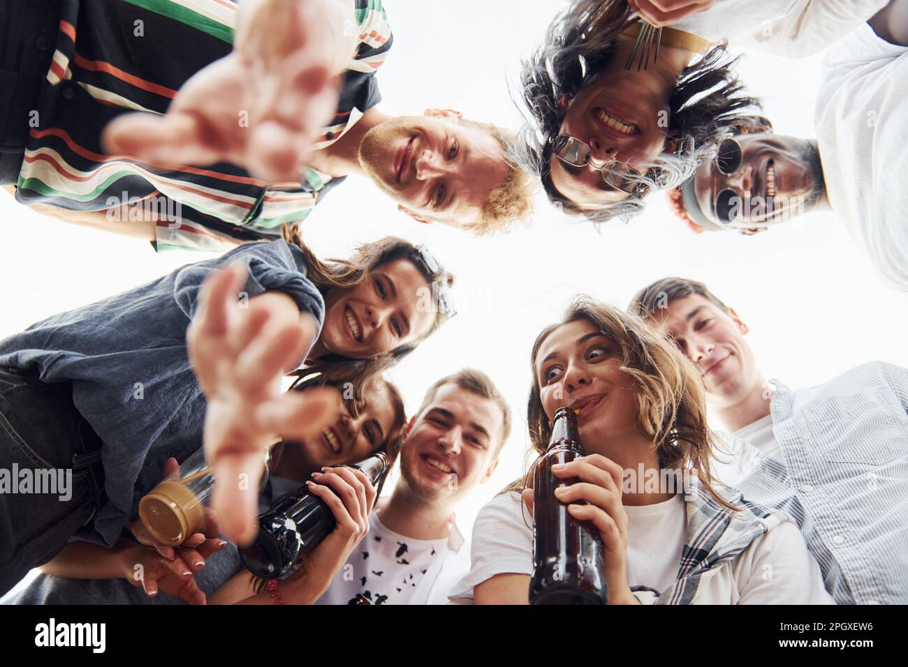 Looking down. View from below. Group of young people in casual clothes ...