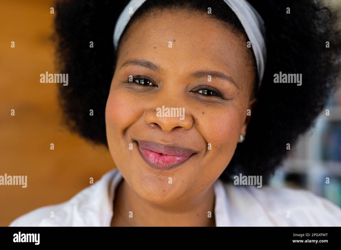 Portrait close up of happy plus size african american woman looking at ...