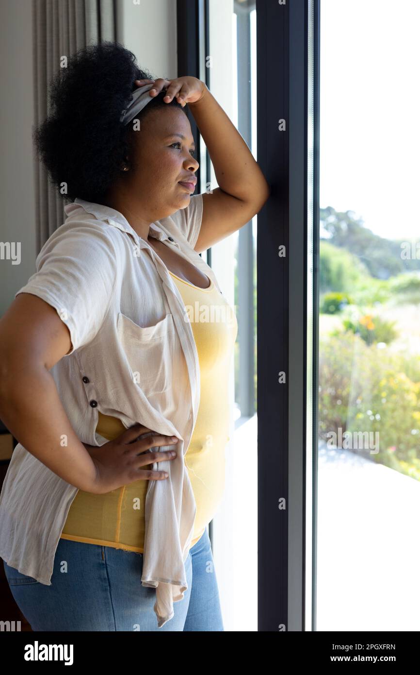 Portrait happy young woman leaning out window hi-res stock photography ...