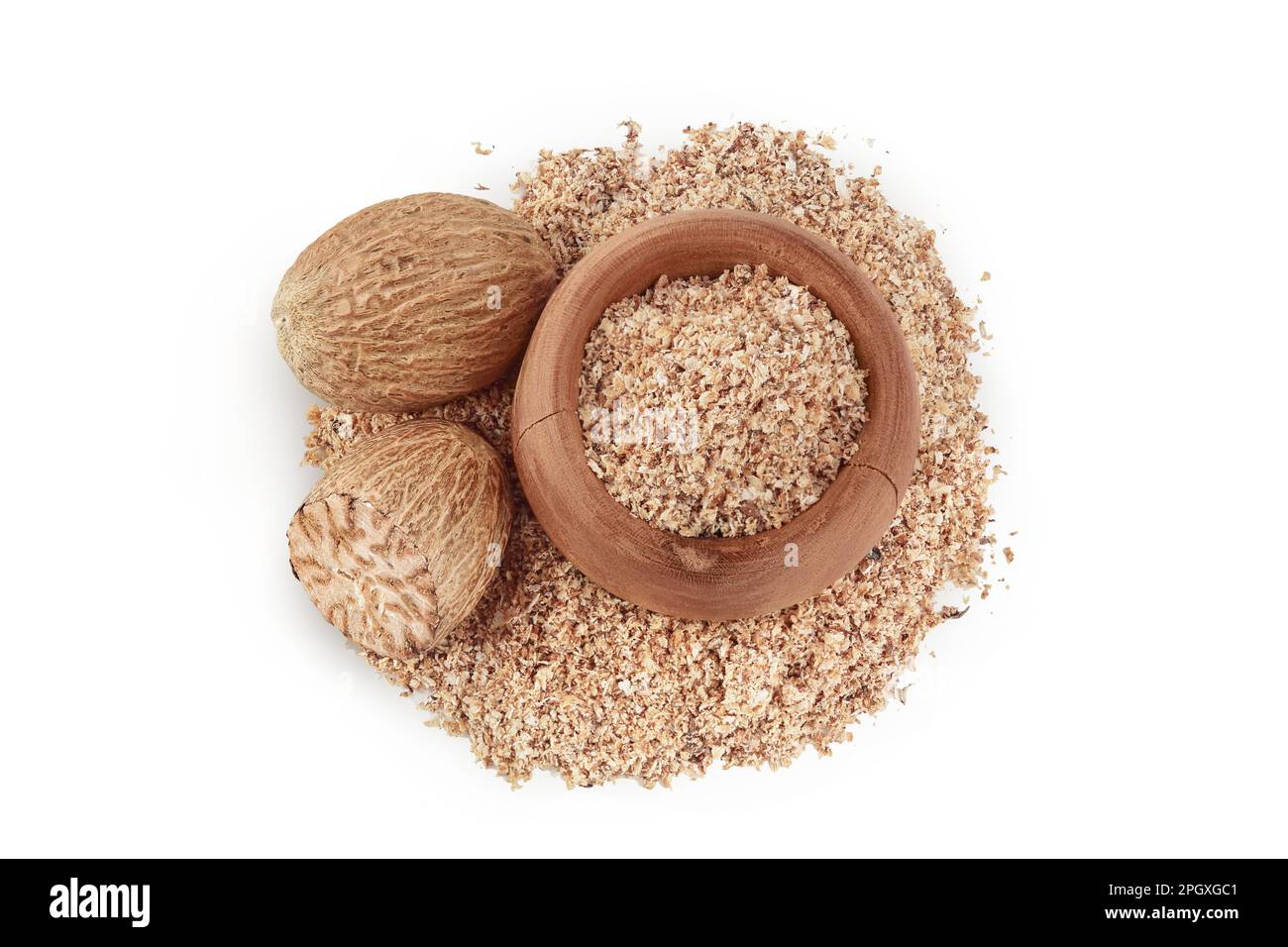 Whole and grated nutmeg in wooden bowl isolated on white background ...