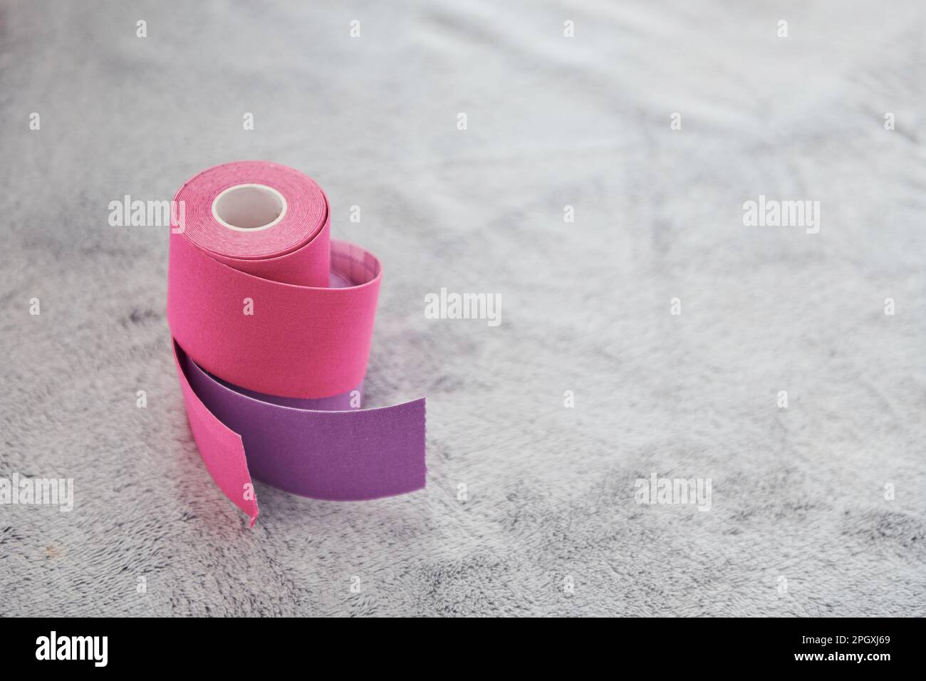 Close up view of physio tape. Two objects that colored pink and violet ...