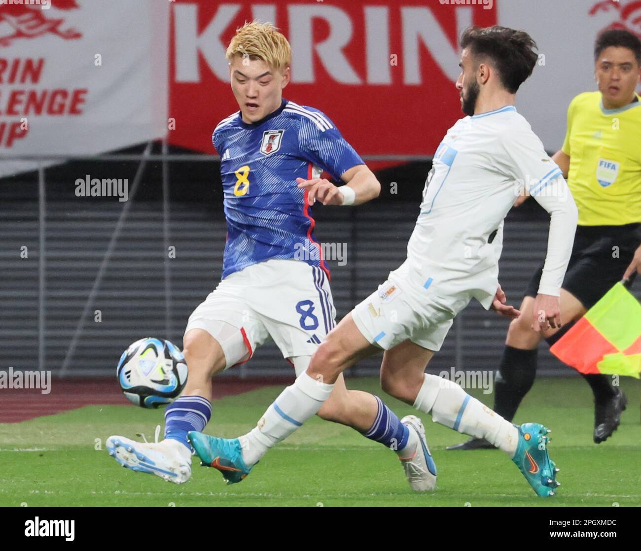 Tokyo, Japan. 24th Mar, 2023. Japan's Ritsu Doan (L) fights the ball against Uruguay's Diego ...